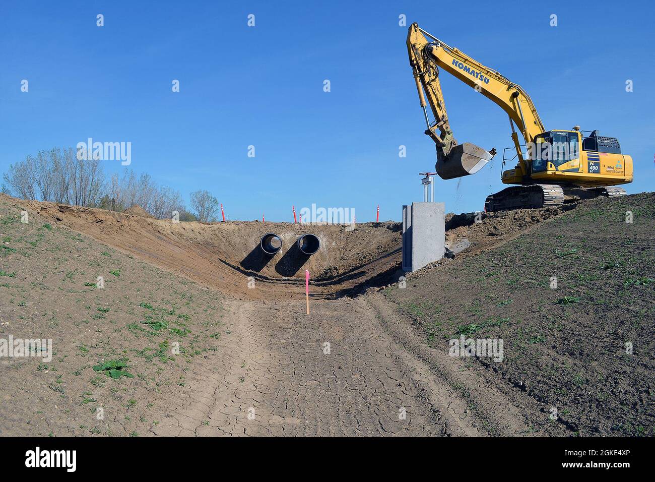 A backhoe shapes the earth around a turnout outlet at the Natomas Reach ...