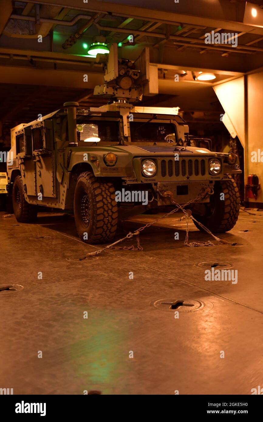 Military vehicles are inside the U.S. Navy's Military Sealift Command's ...
