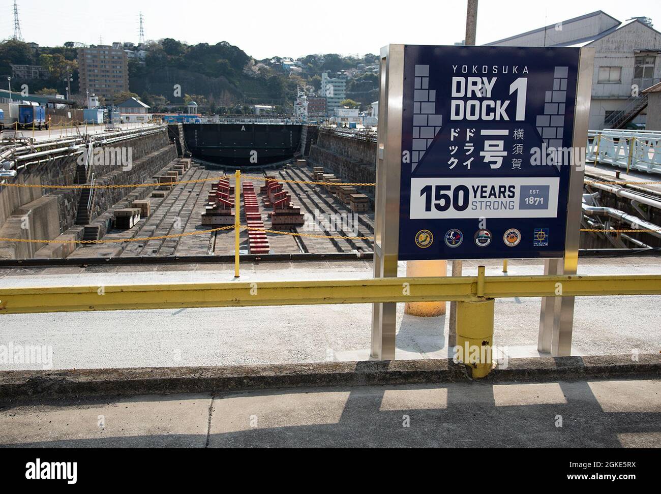 YOKOSUKA, Japan (March 26, 2021) — A new poster stands at the bow of ...