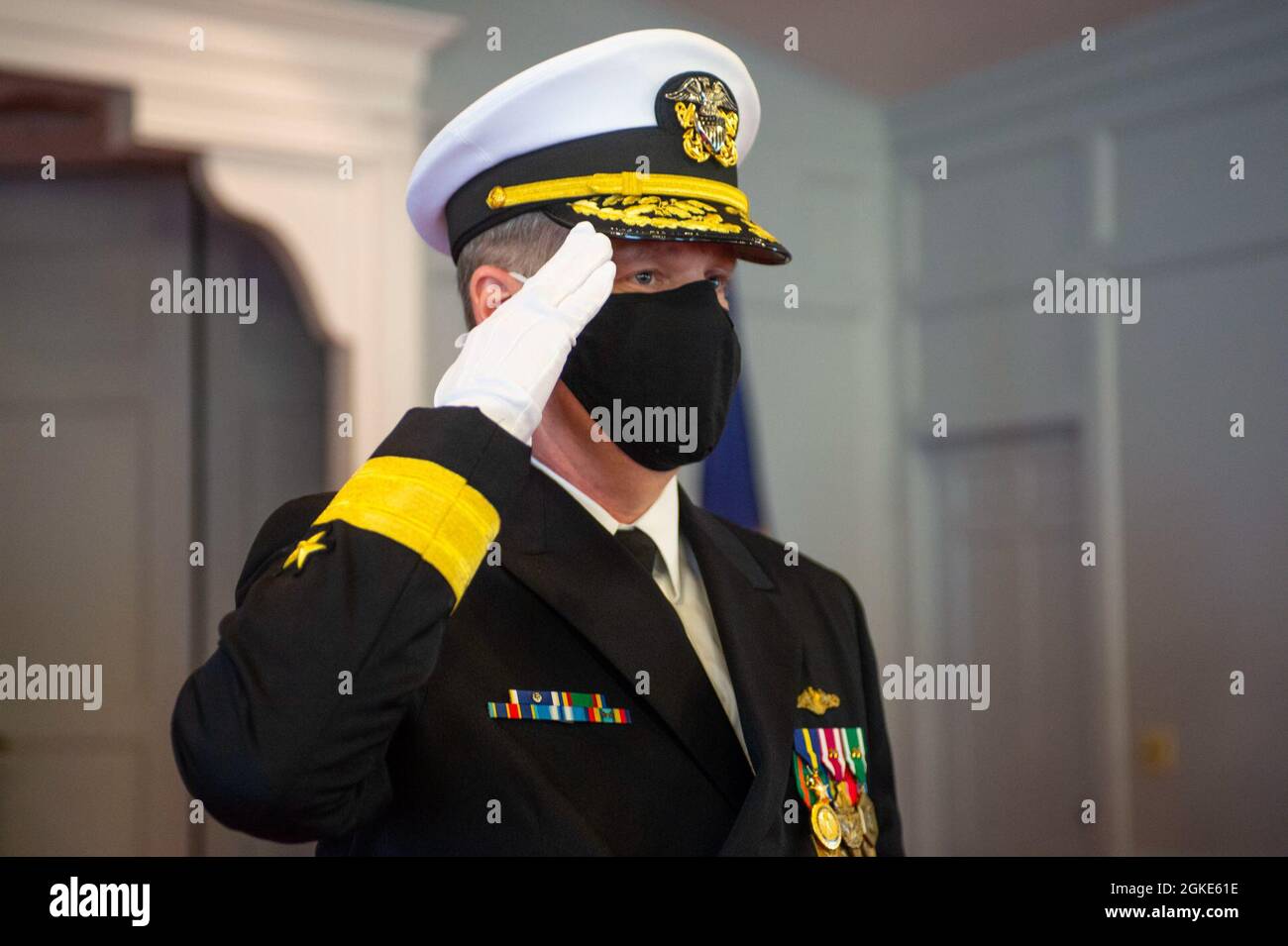 Rear Adm. Brian L. Davies renders a salute during a change of command ...