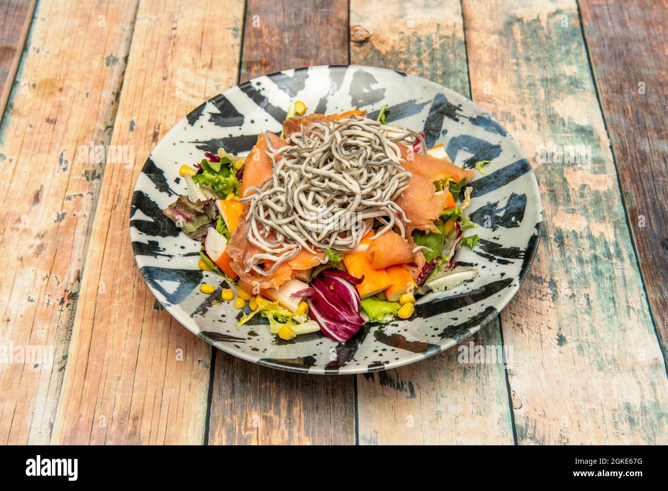 Seafood salad with smoked salmon, chopped surimi, baby eels, lettuce in ...