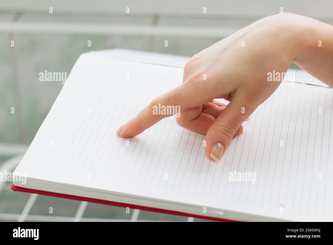 Female forefinger pointing at a business document in a file folder ...