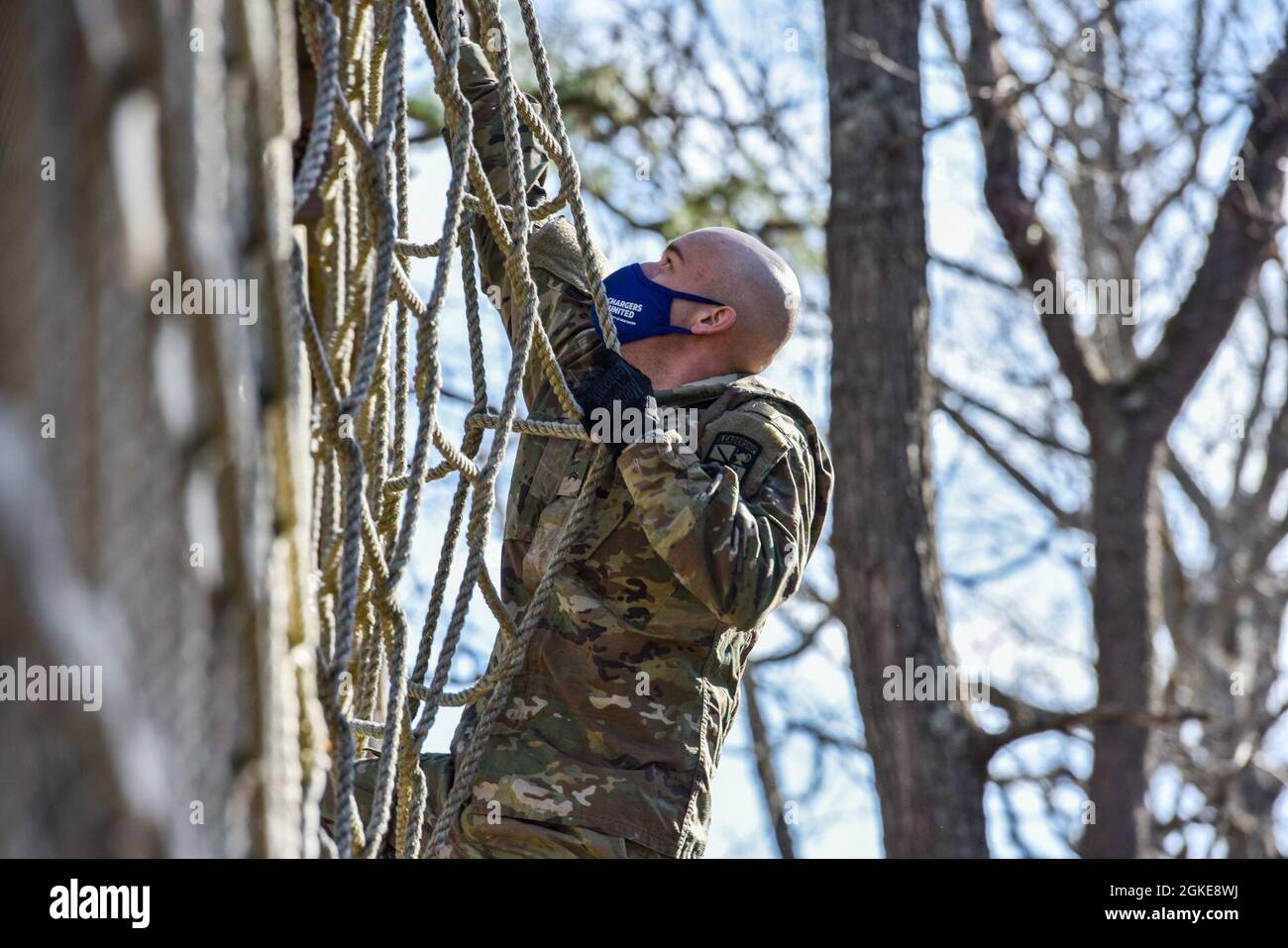 A Reserve Officers' Training Corps cadet scales a rope wall during a ...