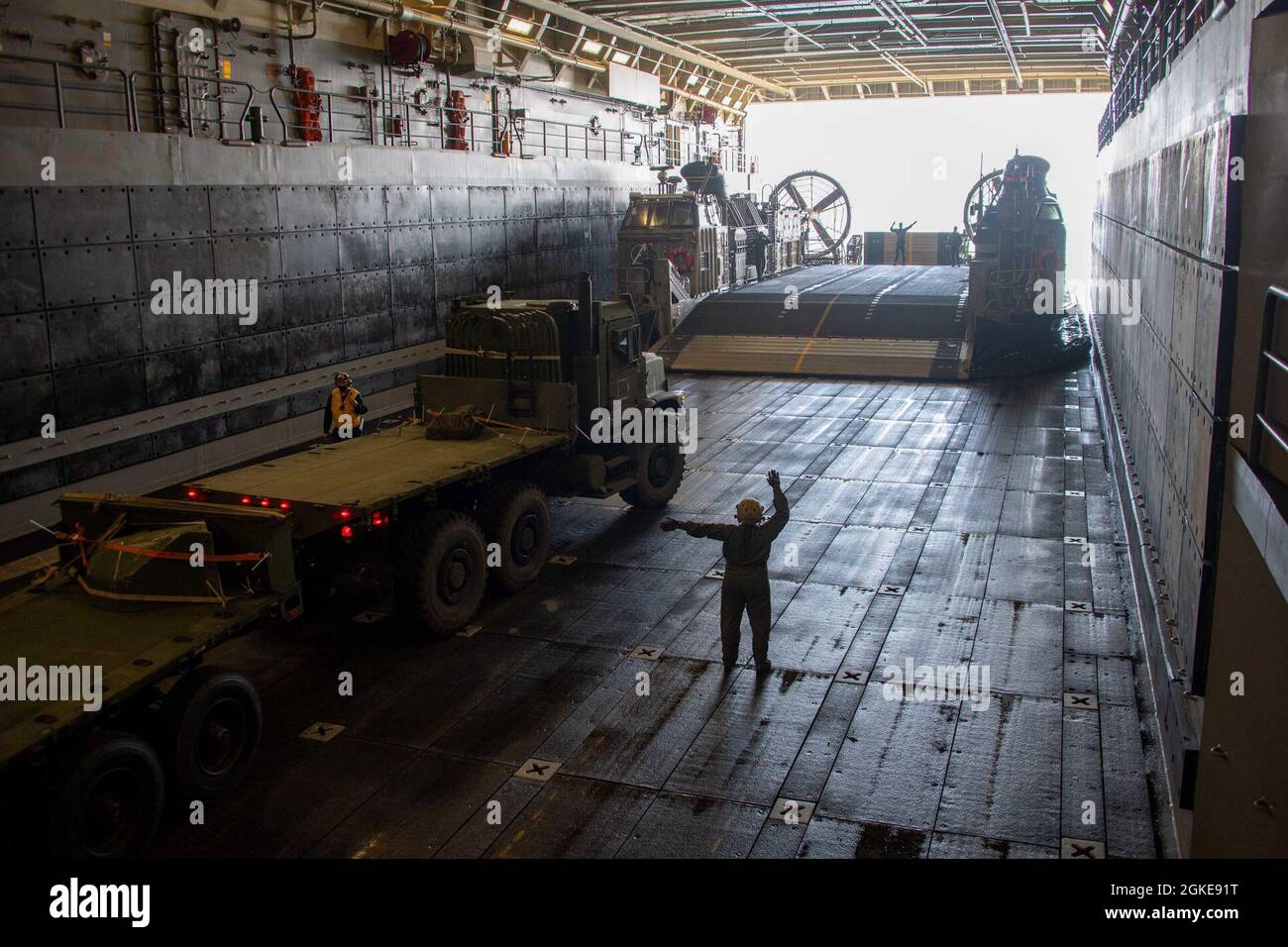 PACIFIC OCEAN (March 27, 2021) Sailors and Marines load a U.S. Marine ...