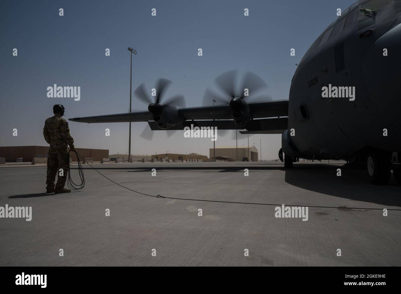 A U.S. Air Force loadmaster watches engine start up on a C-130J Super ...