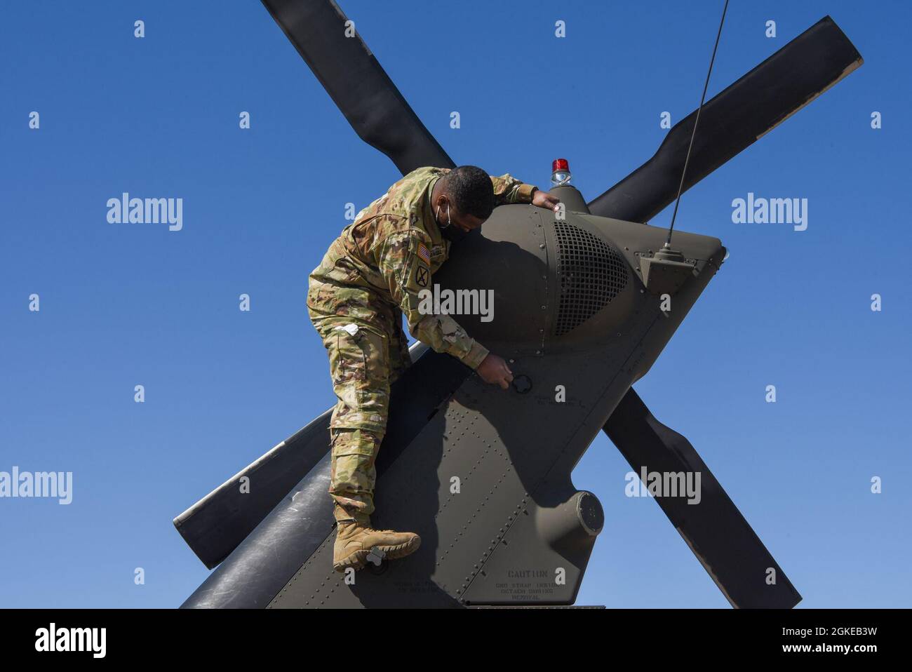 A U.S. Army soldier preforms post-flight maintenance on an UH-60 Black ...