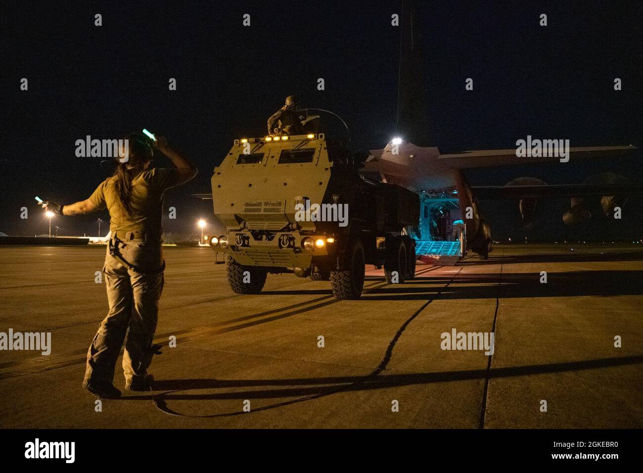 A loadmaster assigned to 352d Special Operations Wing directs marines ...