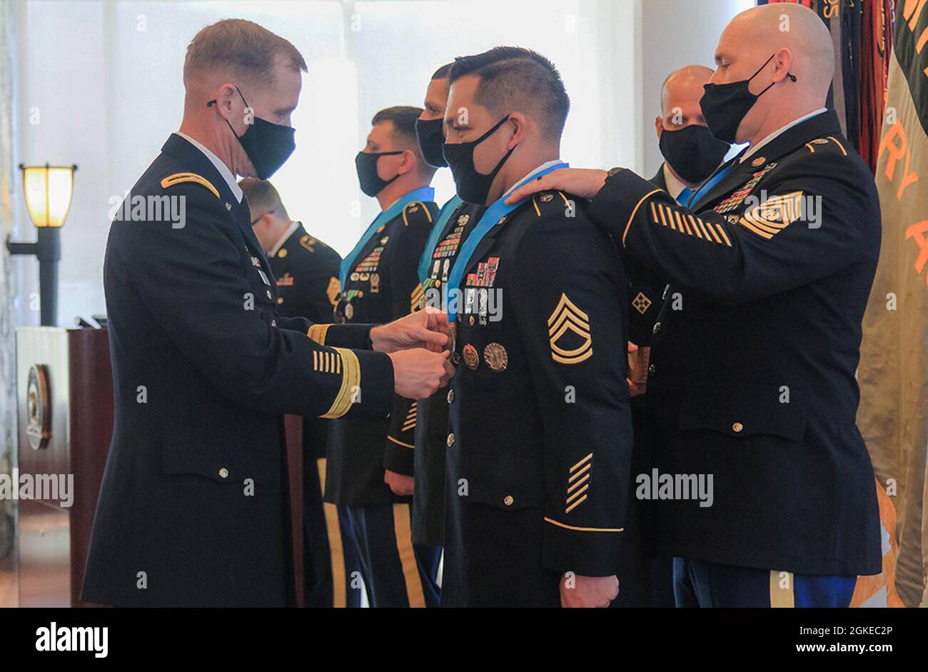 Commandant of Cadets Brig. Gen. Curtis A. Buzzard (left) places the Sgt ...