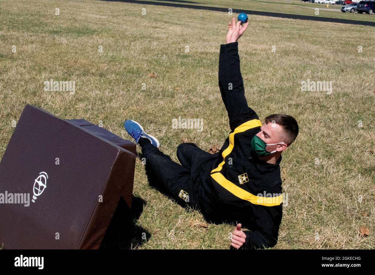 A Michigan Army National Guard soldier throws a grenade to demonstrate ...