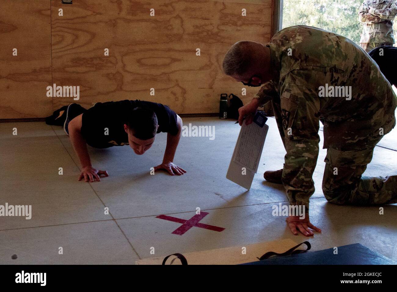 A Michigan Army National Guard soldier does push-ups during an Army ...