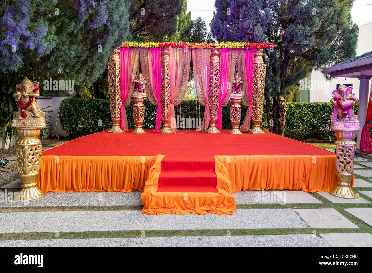 Decorated orange stage at a traditional Indian party in a park on a ...