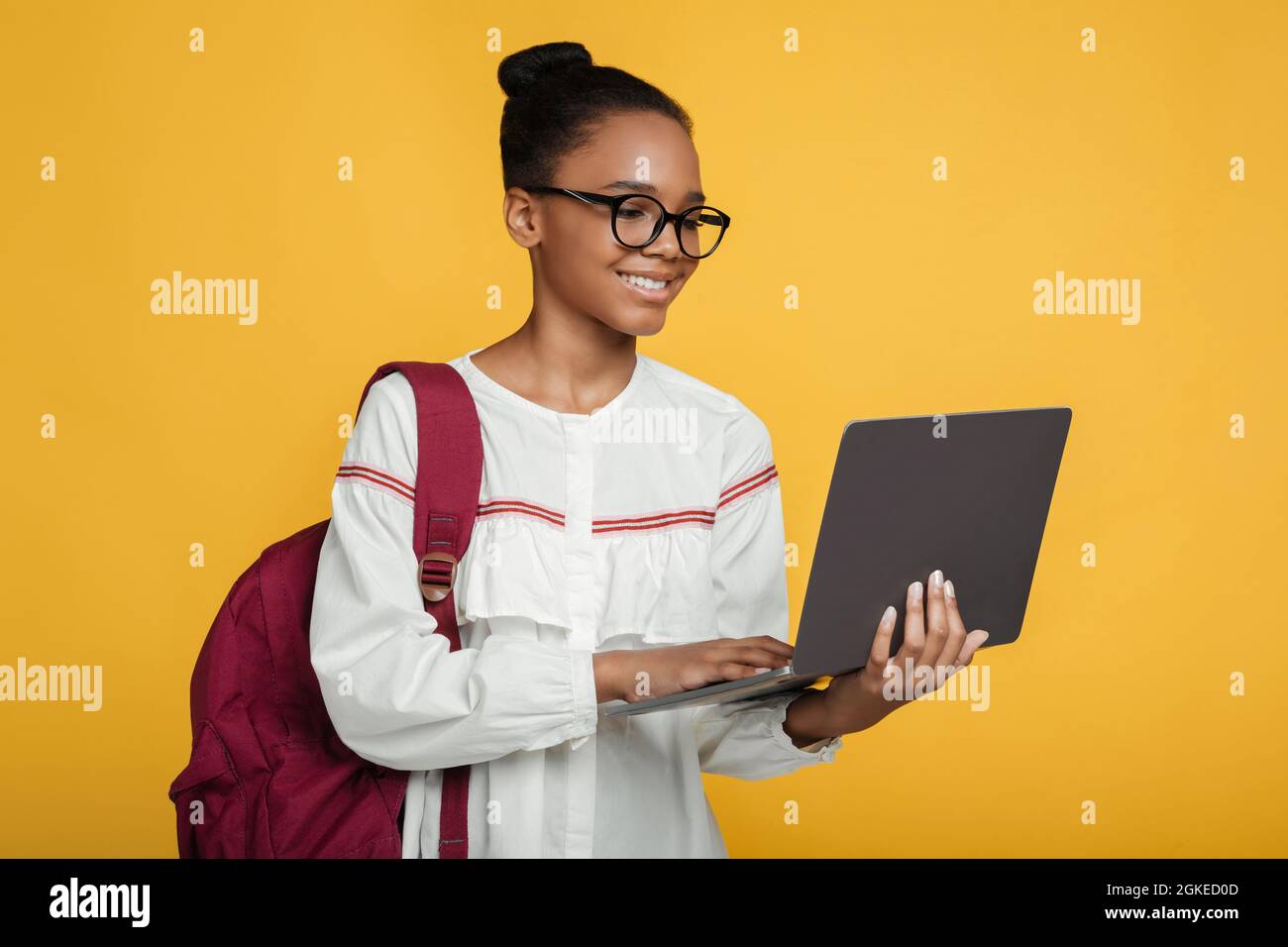 Smiling smart pretty teenage black girl pupil in glasses with backpack ...
