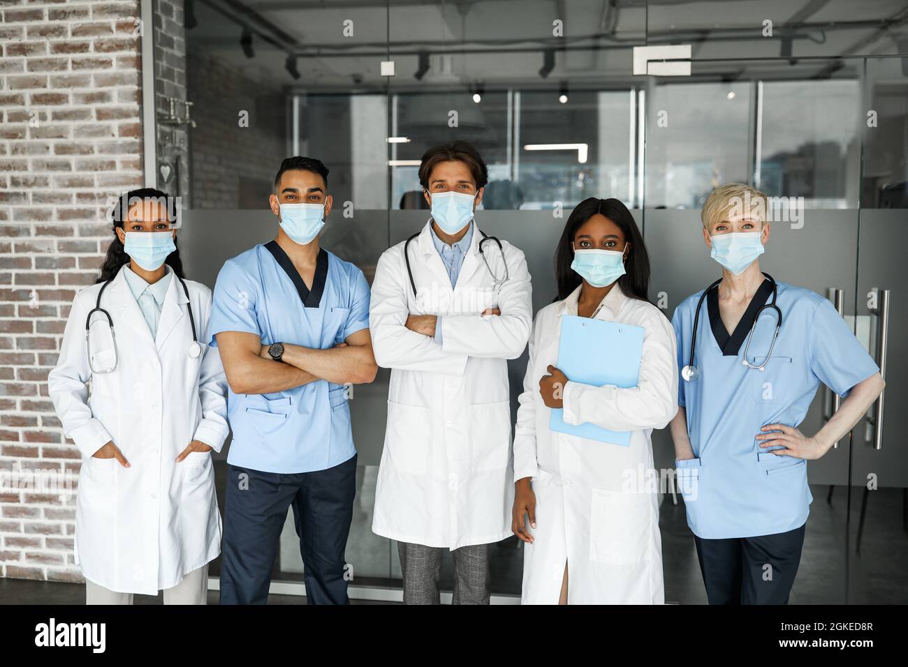 International medical team in face masks having team-building Stock ...