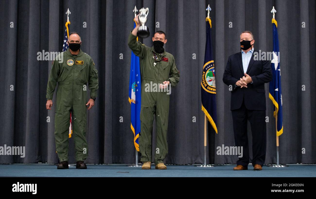 Lt. Col. Christopher Duff, center, raises the Omaha Trophy after ...