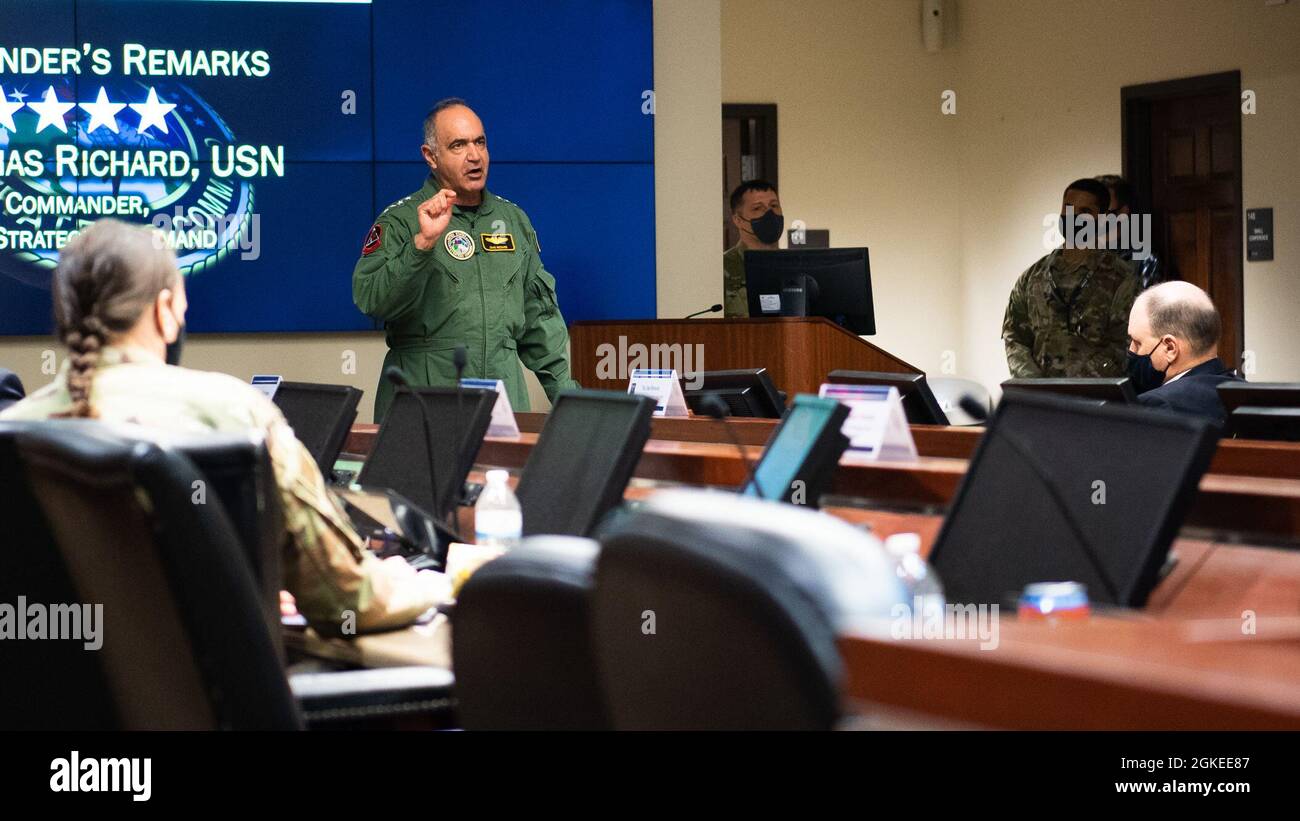 Adm. Charles Richard, U.S. Strategic Command commander, addresses the crowd at a table top ...