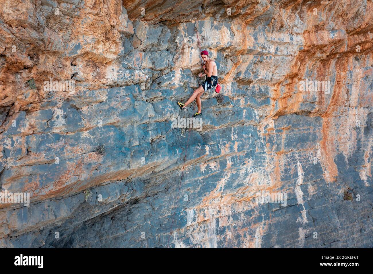 Climber climbing on a rock face, sport climbing, Telendos, near ...