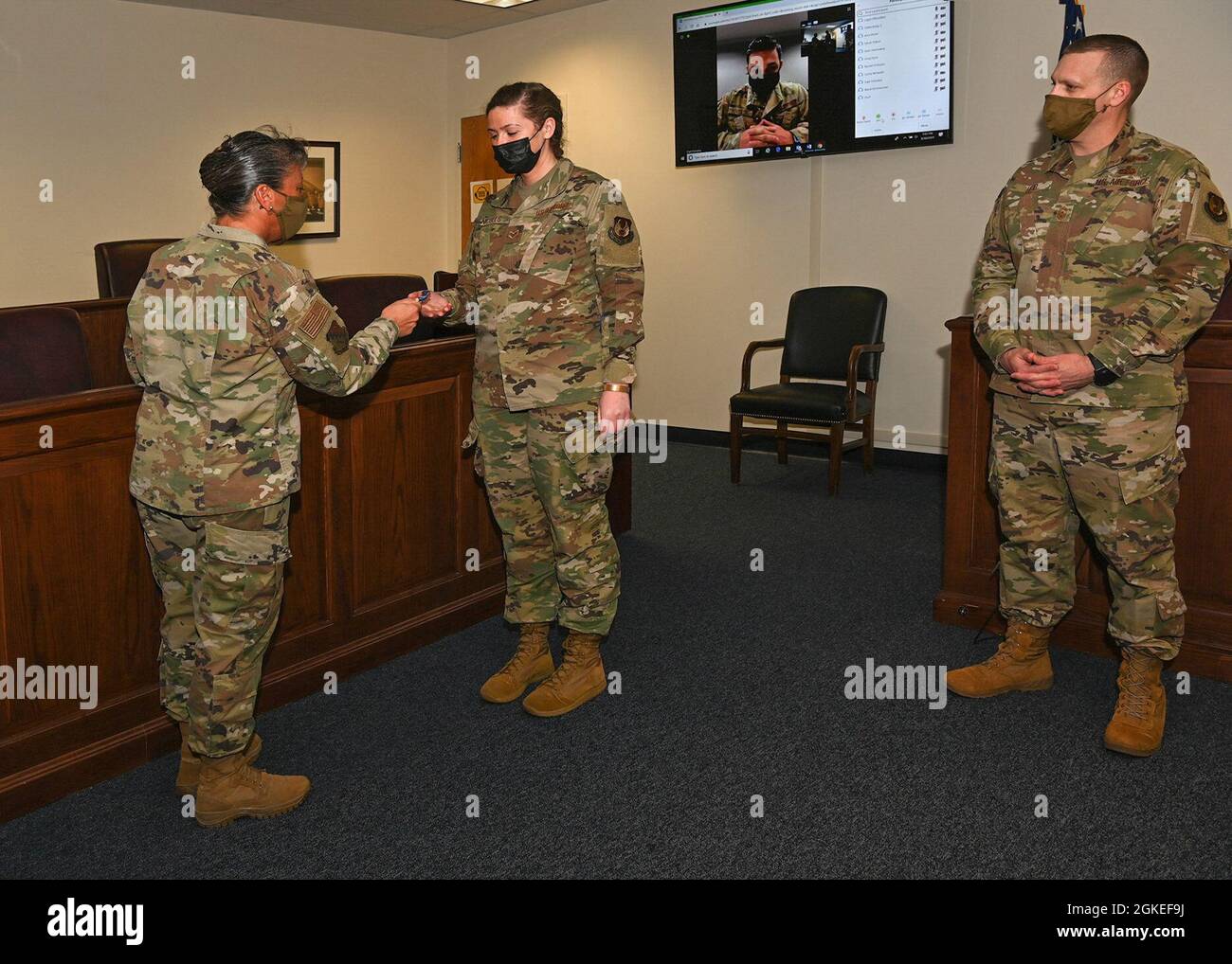 Col. Katrina Stephens, left, 66th Air Base Group commander, presents a ...