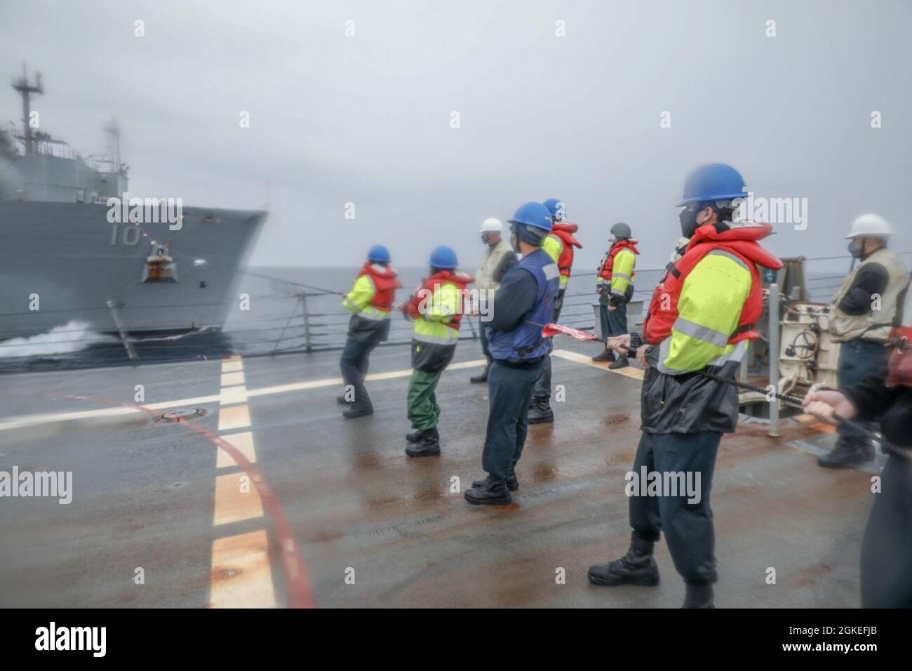 EAST CHINA SEA (March 30, 2021) Sailors hold a line on the fantail of ...
