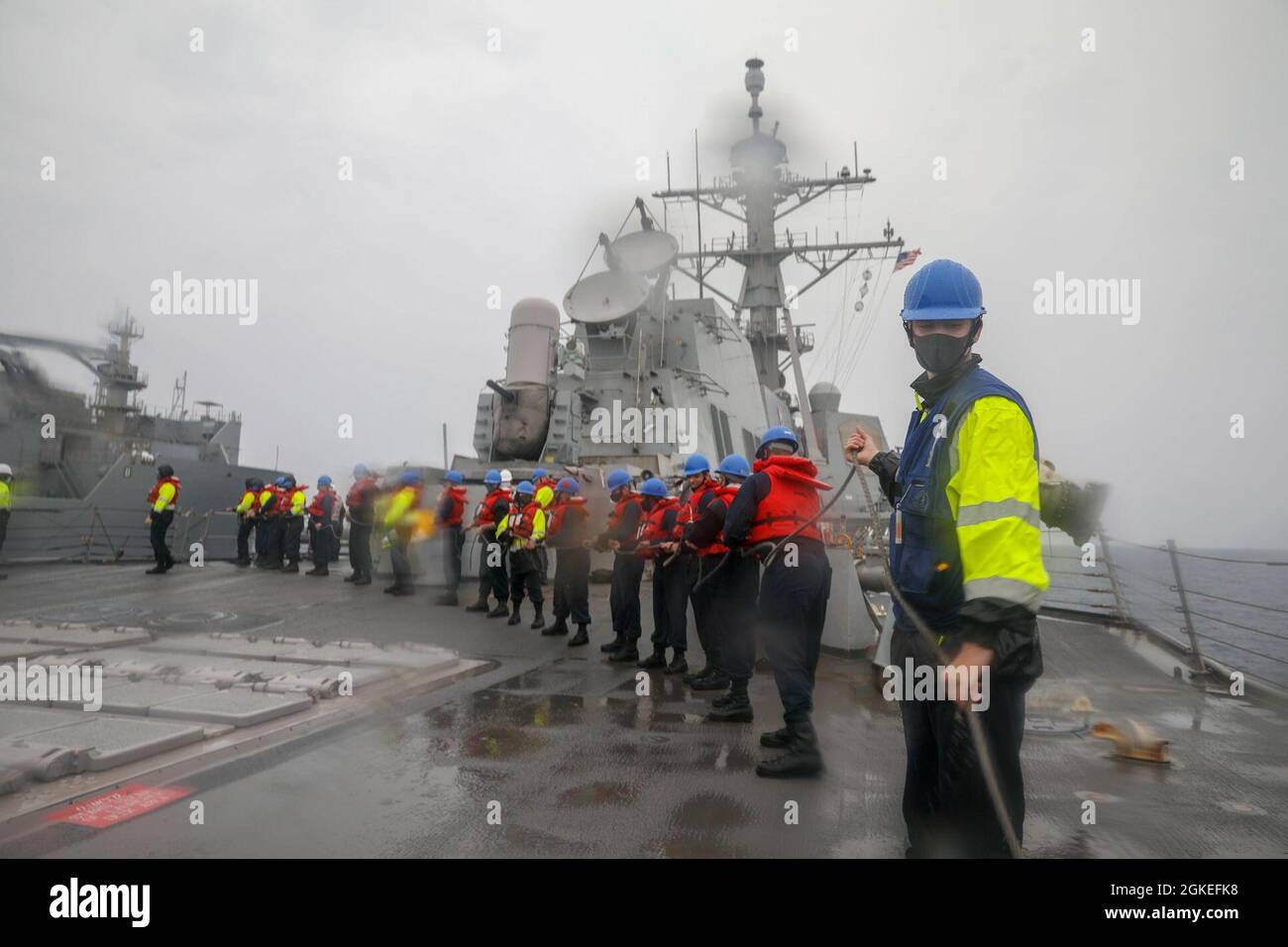 EAST CHINA SEA (March 30, 2021) Sailors hold a line on the fantail of ...