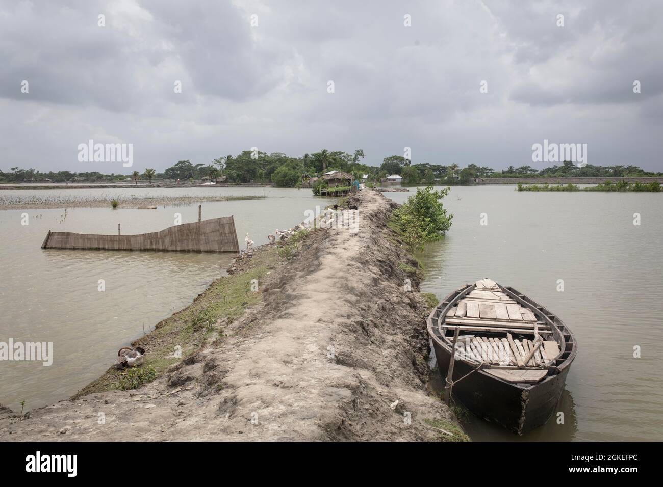Muddy dike, Banishanta peninsula, left and right water basins, moored ...