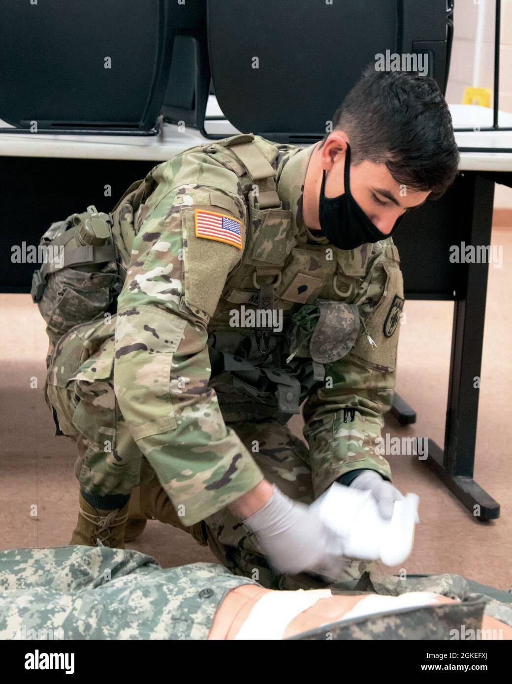 A Michigan Army National Guard soldier puts dressing on a wound to show ...