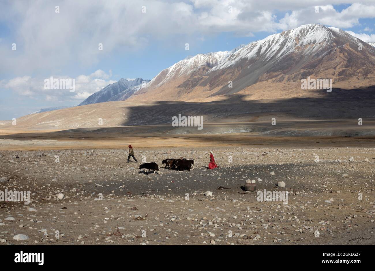 A Kyrgyz woman in traditional traditional costume and a man bring three ...