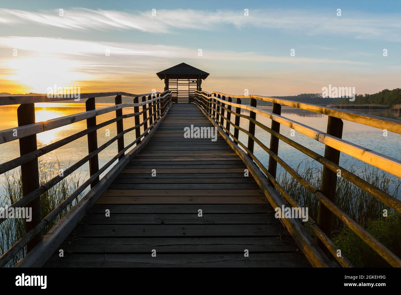 sunset over the lake, wooden pier and a covered observation deck Stock ...