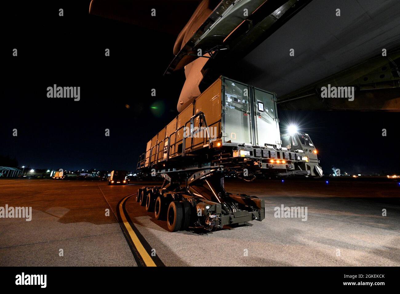 A K loader holding six ISU-90 containers moves toward a C-5M Super ...