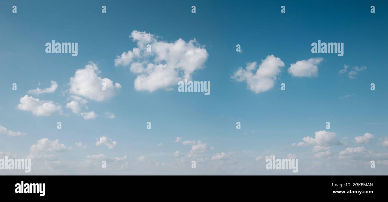 blue sky with white fluffy clouds in midday Stock Photo - Alamy