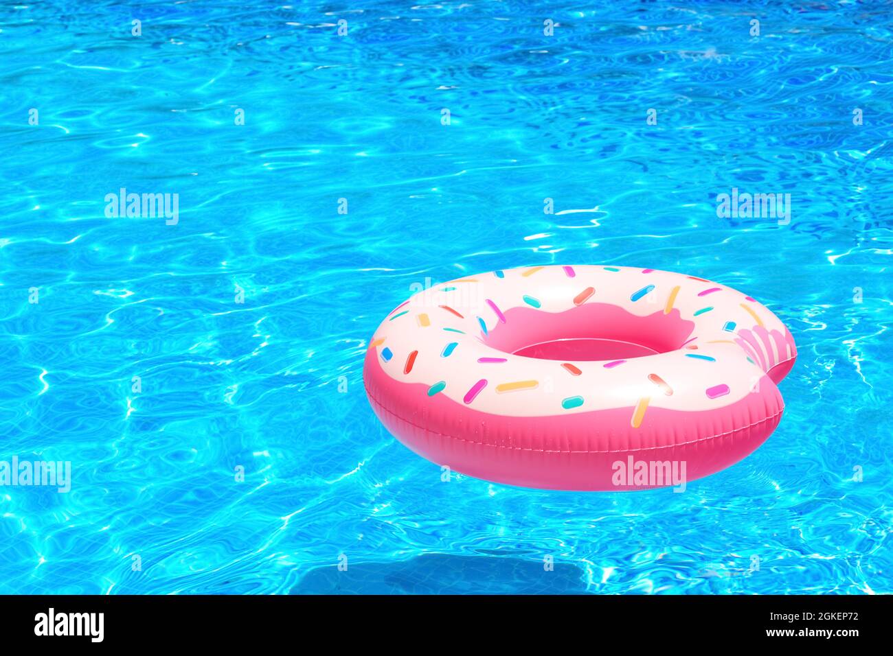 Colorful inflatable donut in blue swimming pool Stock Photo - Alamy