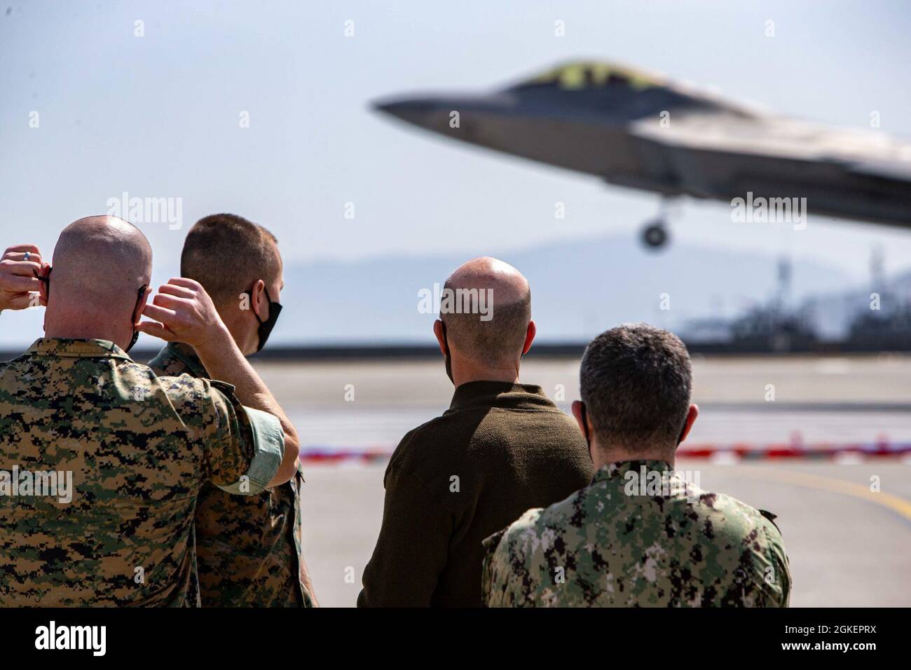 U.S. Navy Vice Admiral Bill Merz, center, commander of 7th Fleet, and ...