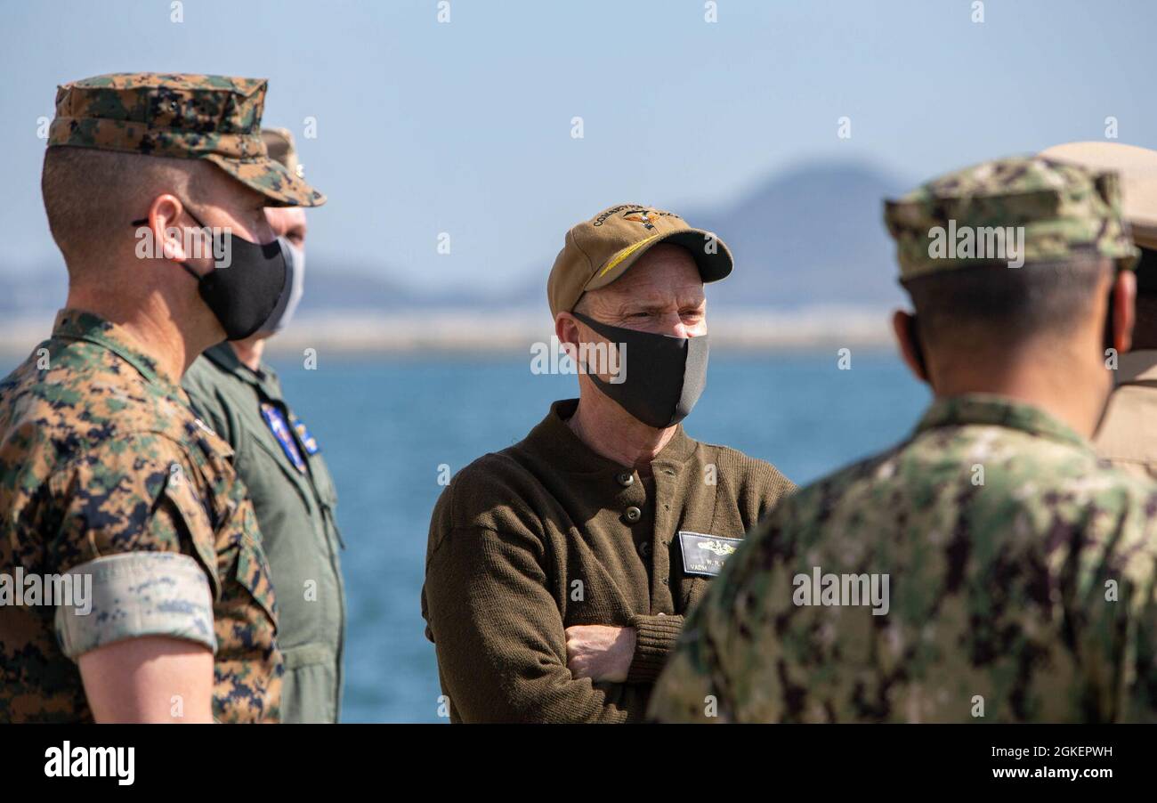 U.S. Navy Vice Admiral Bill Merz, center, commander of 7th Fleet, and ...