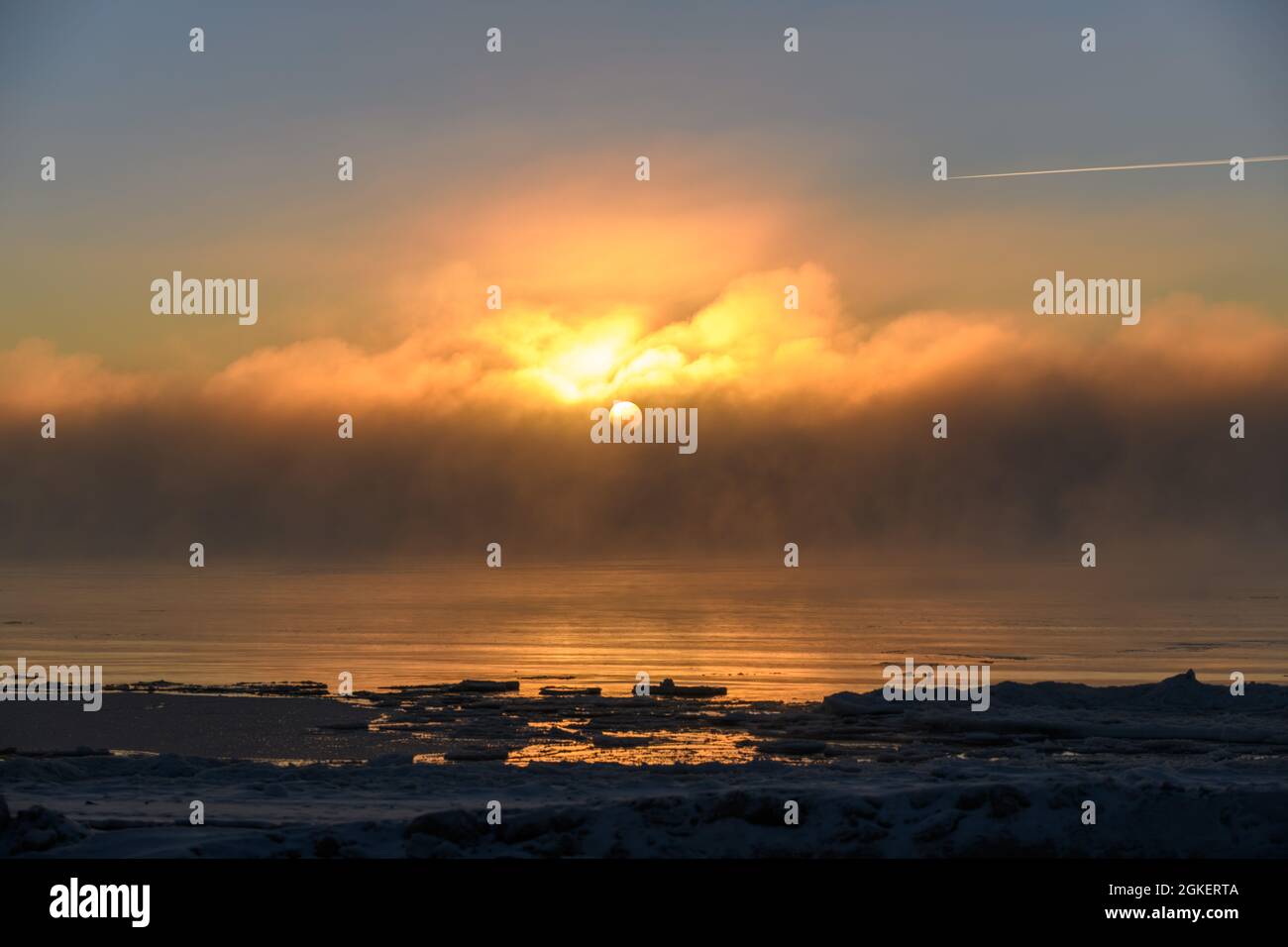 Beautiful sunset with fog in Arctic sea at winter time. Fog at sea ...