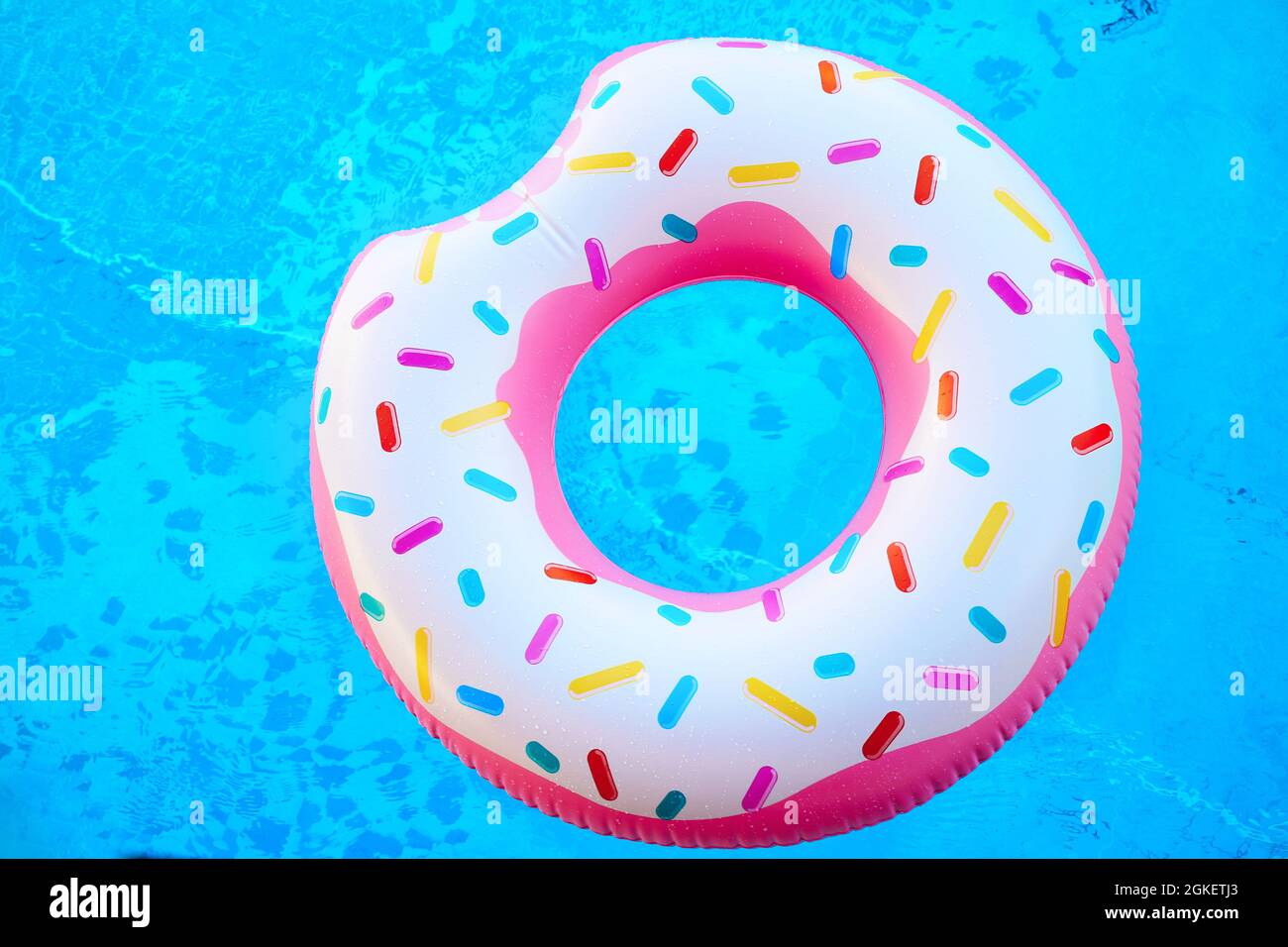 Inflatable colorful donut in blue swimming pool Stock Photo - Alamy