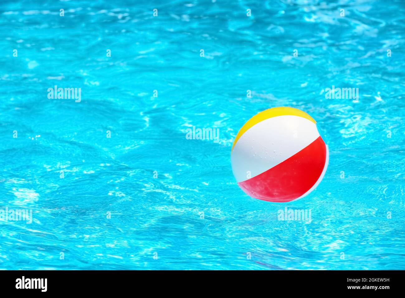 Colorful inflatable ball in blue swimming pool Stock Photo - Alamy