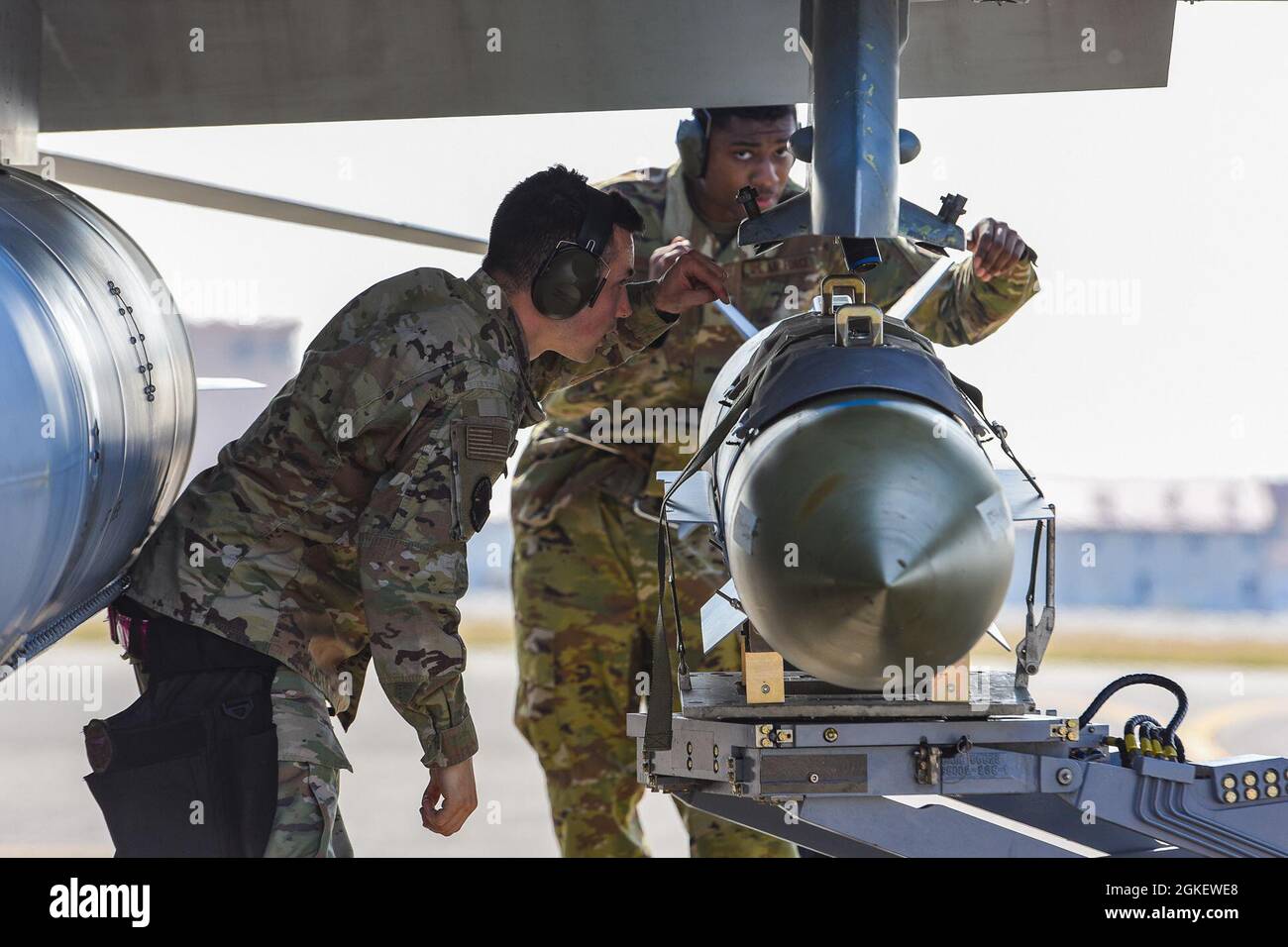 Tech. Sgt. Alec Lamarca, 31st Aircraft Maintenance Squadron weapons load crew chief, left, and ...