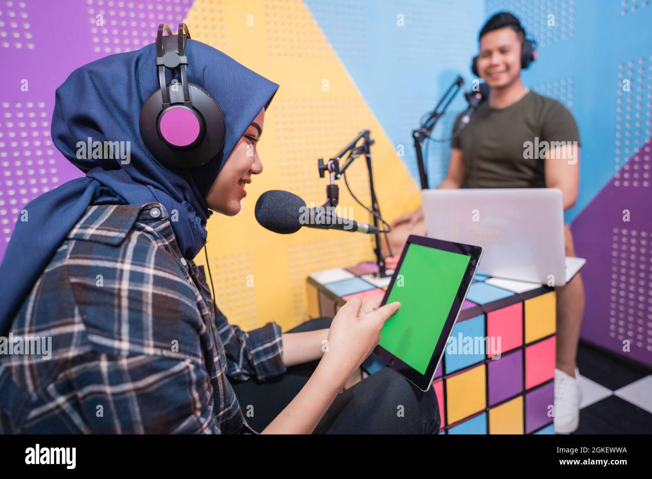 muslim asian woman and man talking on podcast studio together Stock ...