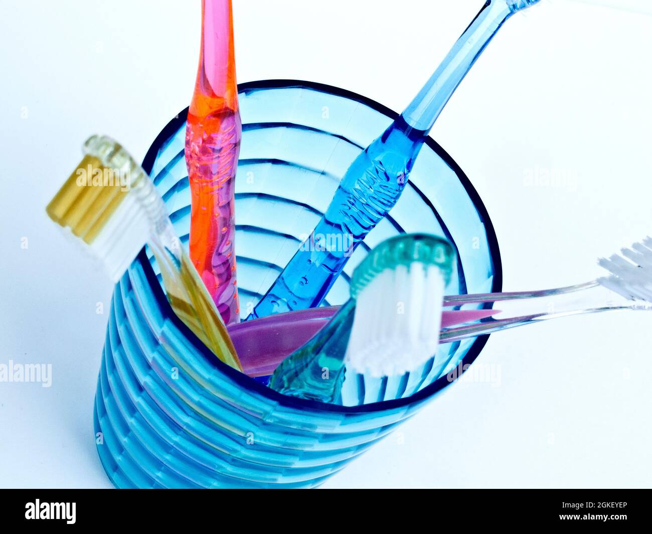 Tooth brushes in a glass isolated on white background Stock Photo - Alamy