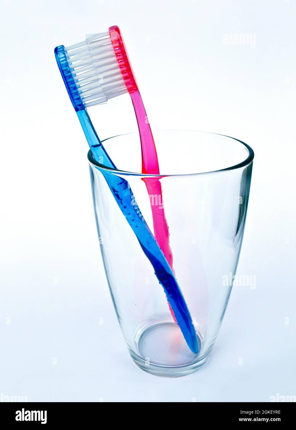 Tooth brushes in a glass isolated on white background Stock Photo - Alamy