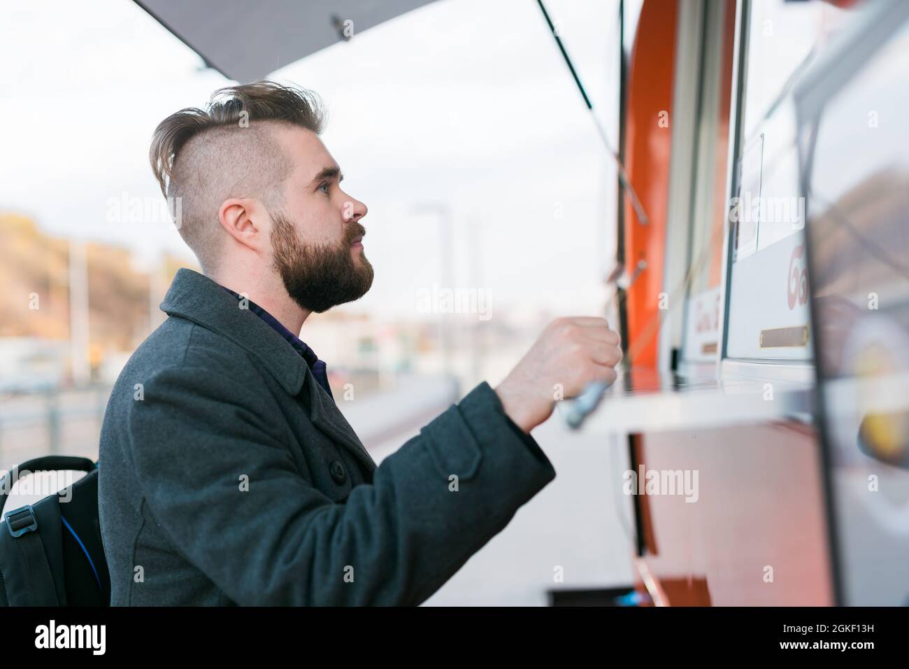 Portrait of man choosing fast food in food truck in the street. Meal ...