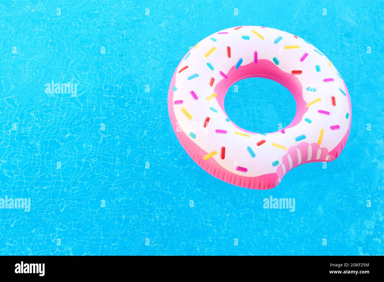 Inflatable colorful donut in blue swimming pool Stock Photo - Alamy