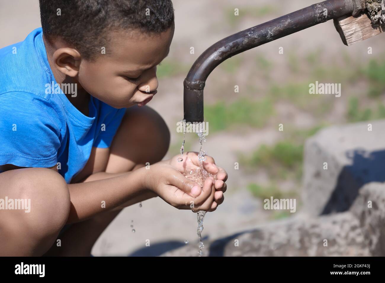 African boy drinking tap water hi-res stock photography and images - Alamy