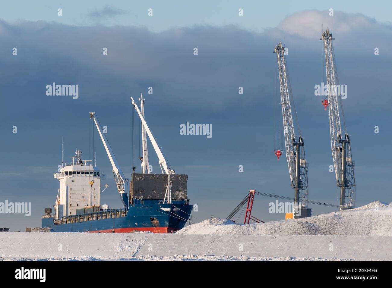 Cargo vessel moored in arctic port. Winter time. Ice navigation ...