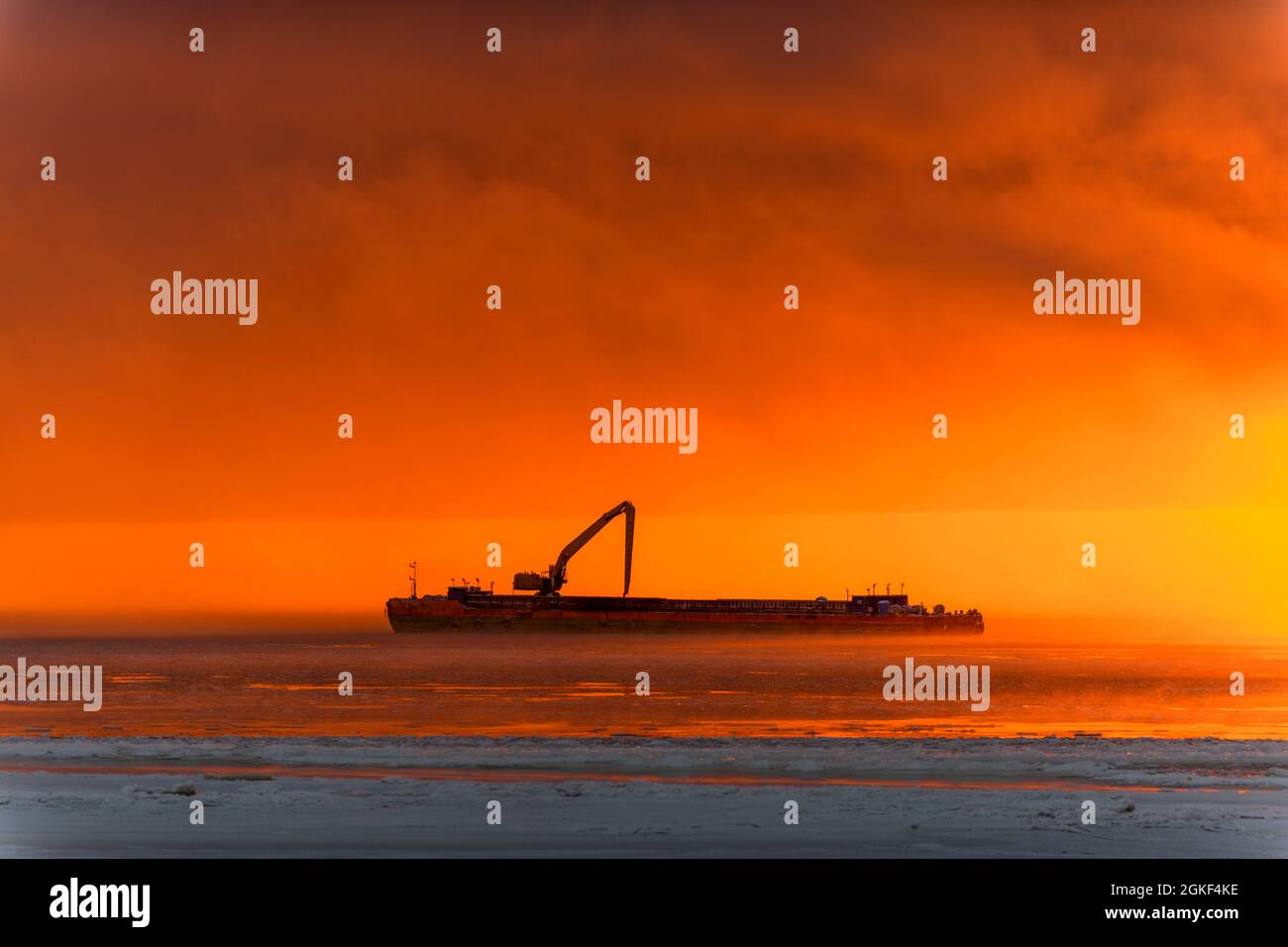 Beautiful sunset with fog in Arctic sea. Barge with excavator Stock ...