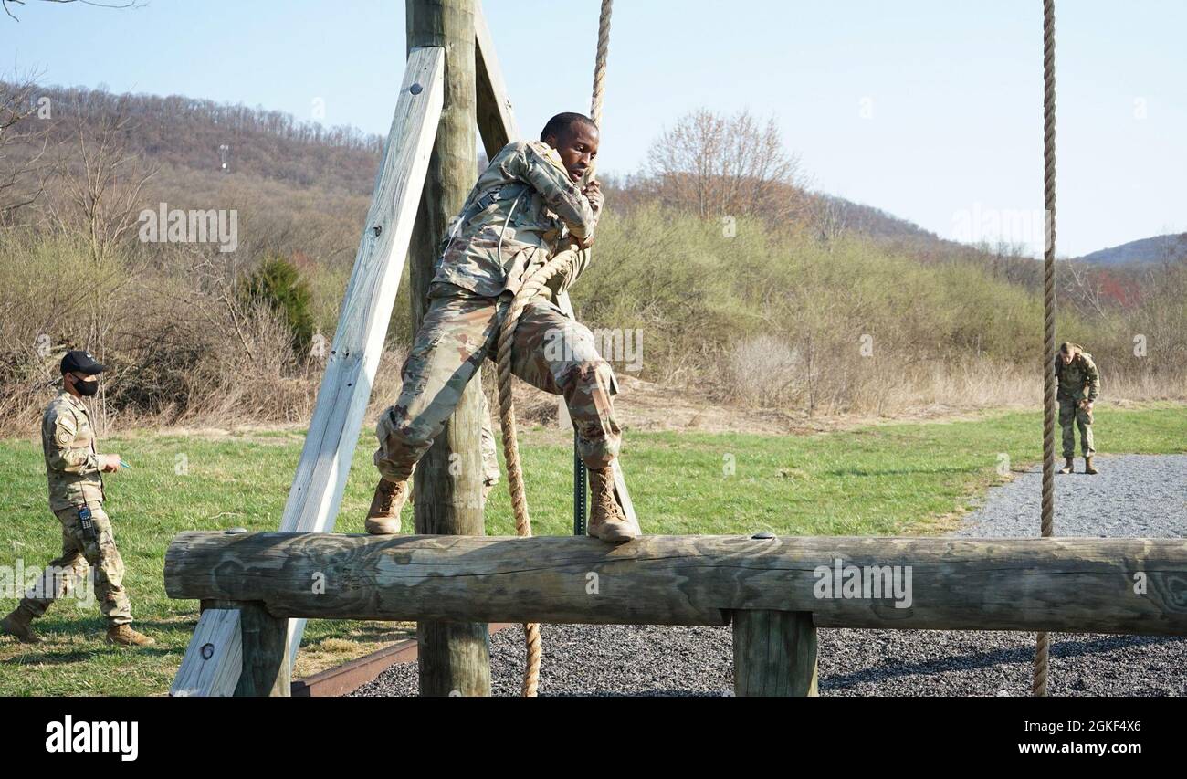 A Soldier swings onto the raised platform, one of the last obstacles ...