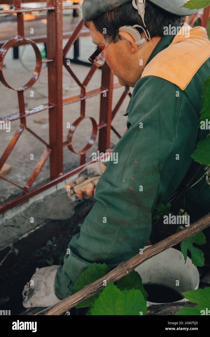Construction technicians with hearing aid working with cement paving ...