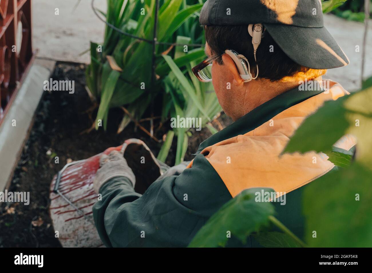 Construction technicians with hearing aid working with cement paving ...