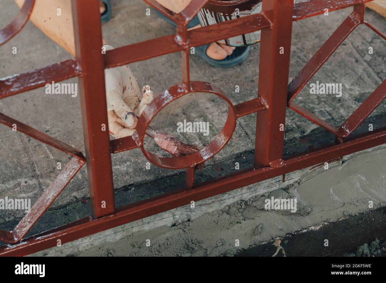 Construction technicians with hearing aid working with cement paving ...