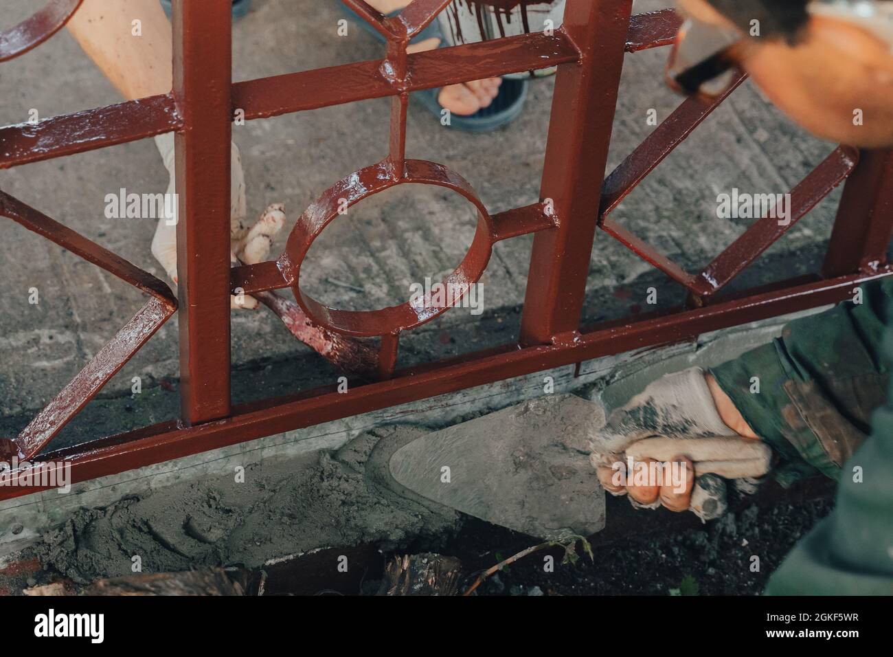 Construction technicians with hearing aid working with cement paving ...