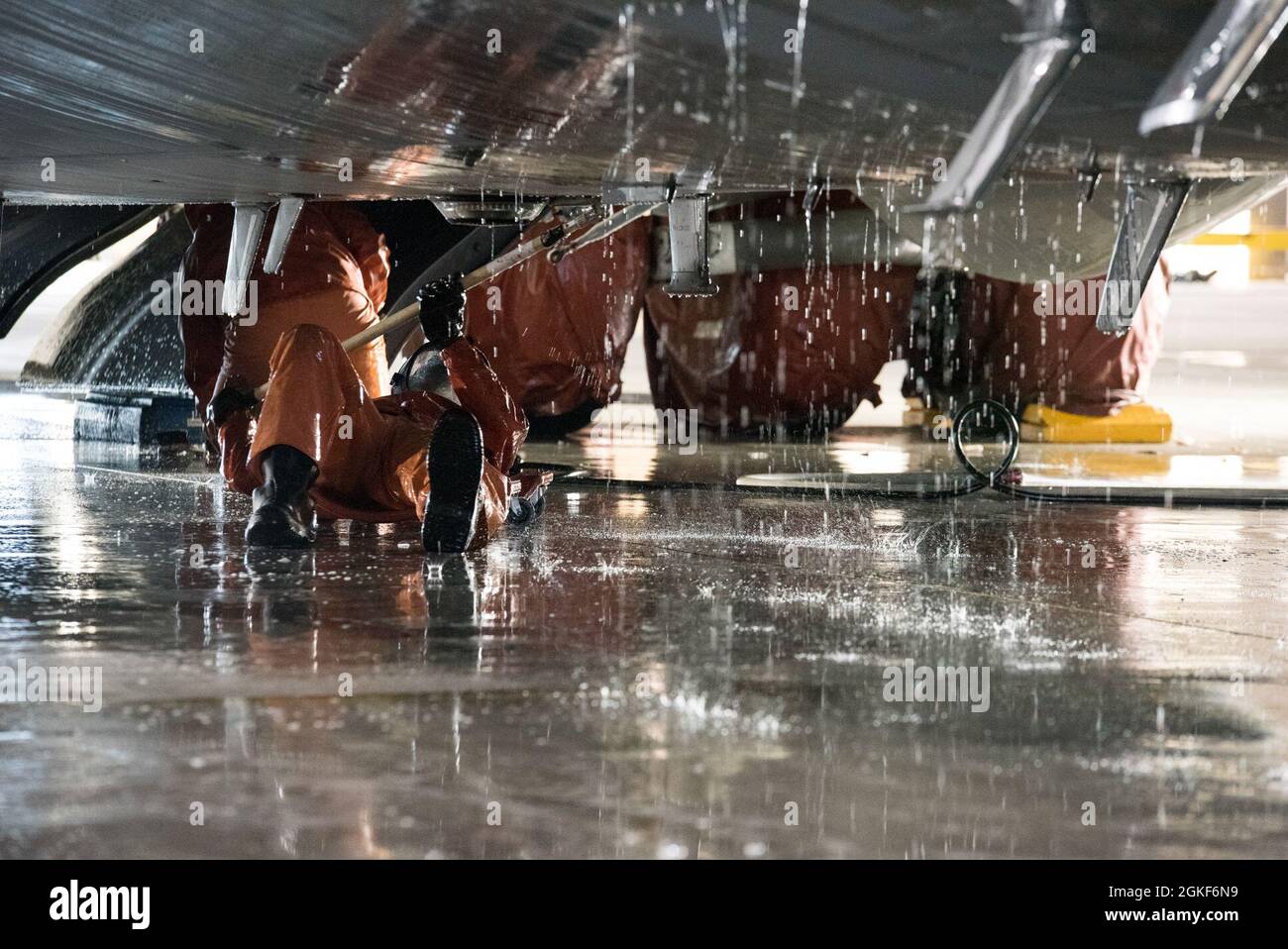 Members of the 167th Airlift Wing Maintenance Group scrub the belly of ...